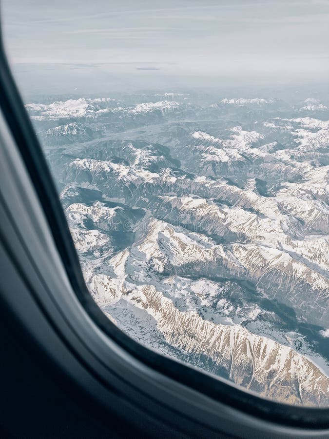 View of the Alpine Mountains with Snow from the Aircraft Window Stock ...