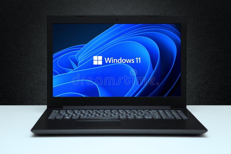 Windows 11 Logo on the Screen Laptop Computer Black Textured Wall with ...