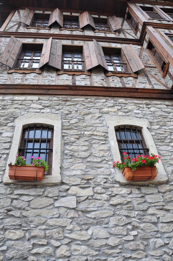 Swiss Log Chalet Window with Red Geranium Flowers Stock Image - Image ...