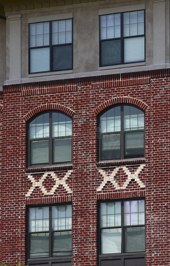 Red Trim Windows on Stone Building with Green Trim Stock Image - Image ...