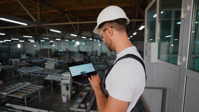 Windows Factory Chief Engineer is Using a Laptop with an Engineering ...