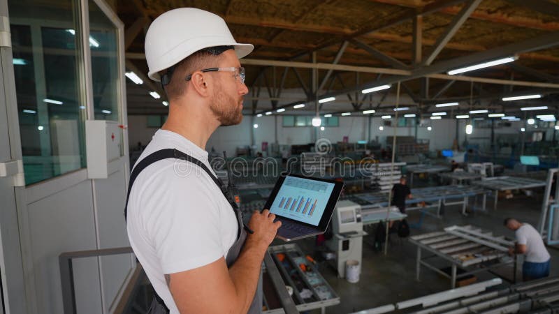 Windows Factory Foreman is Using a Laptop with an Engineering Software ...