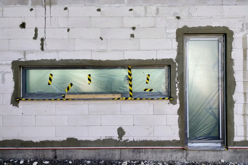 Windows of a House Under Construction Covered with Protective Plastic ...