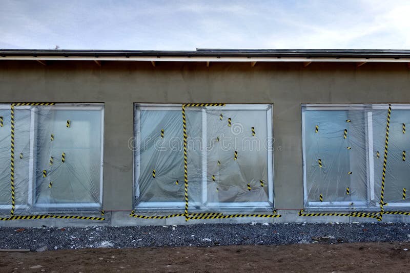 Windows of a House Under Construction Covered with Protective Plastic ...