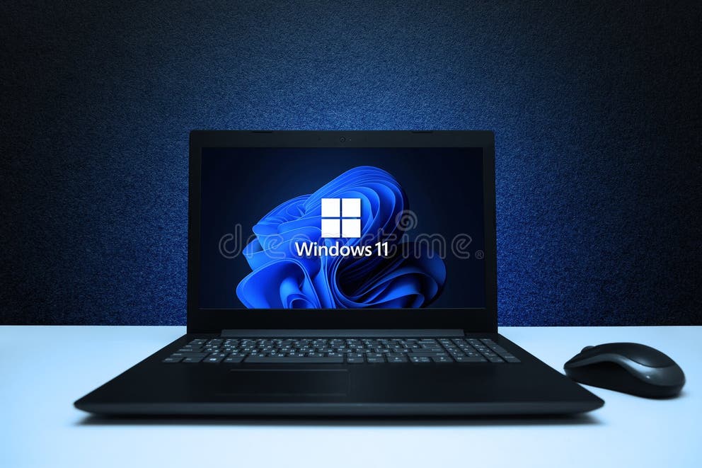 Windows 11 Logo on the Screen Laptop Computer with Mouse on Black ...