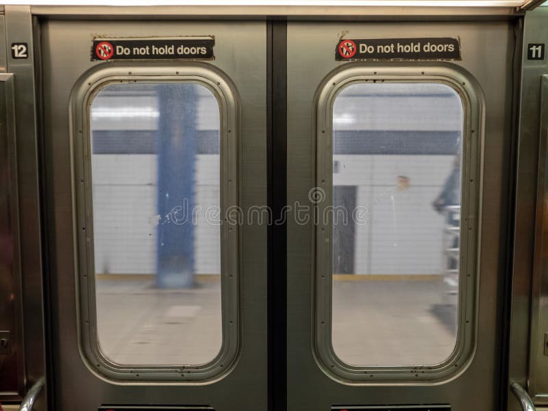 Windows of a Moving Subway Train Looking Out into Station Platform upon ...