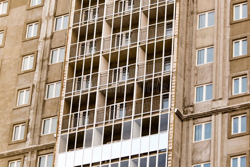 Windows in a Multi-storey Building Under Construction As a Background ...