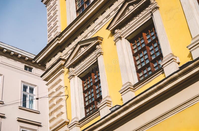 Windows of the Old European House are Yellow with a Bas-relief Over the ...