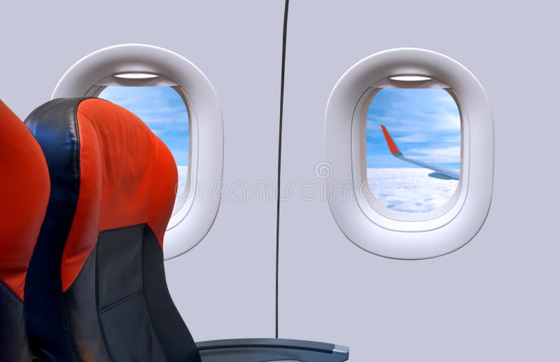 Windows and Passenger Seats in Airplane Cabin while the Plane Flying ...
