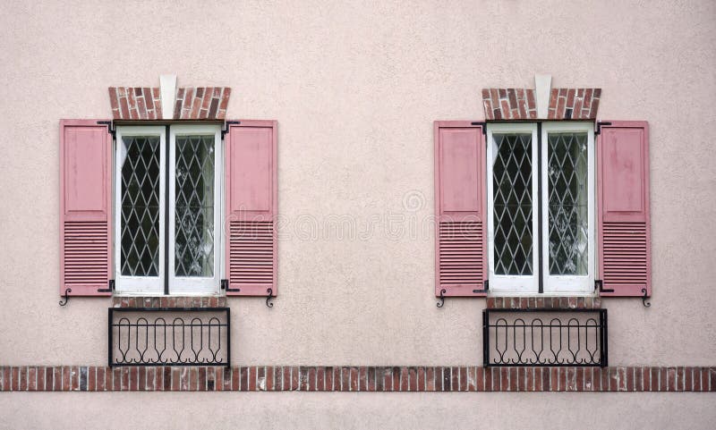 Windows with pink shutters stock image. Image of exterior - 331573143