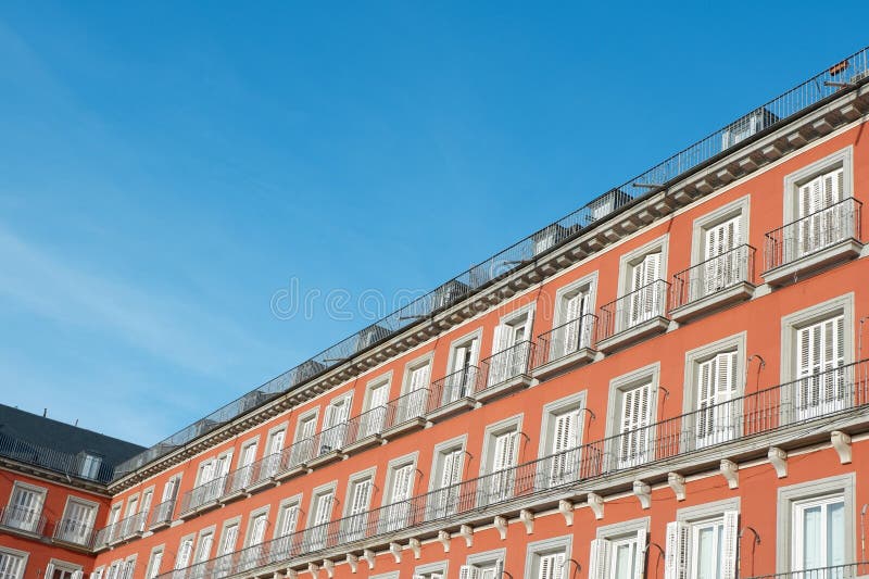 Windows with Shades and Railing Balconies on the Facade of Red Colour ...