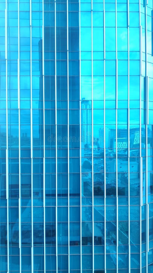 The Windows of the Tall Building are Blue with White Frames that ...