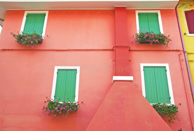 Windows with Windowsill Flower on the Red Facade Stock Photo - Image of ...