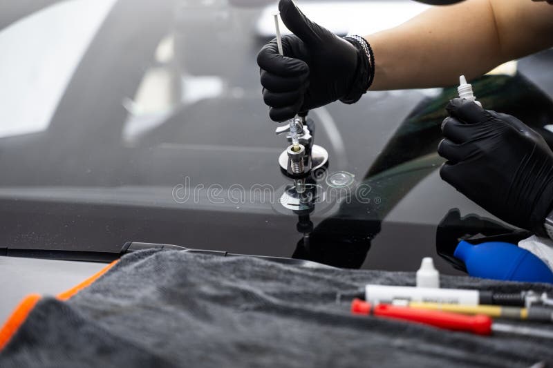 Windshield Crack Repair Using Resin Injection. Technician Using ...
