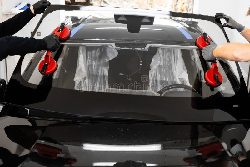 Windshield Installation Using Suction Lifters. Two Technicians Install ...