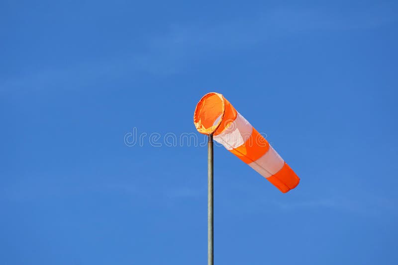 Orange and White Striped Windsock Against a Blue Sky. a Simple ...