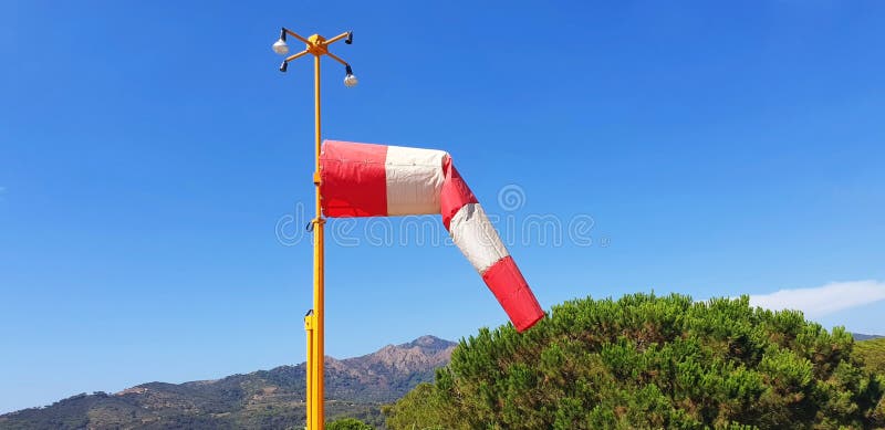Windsock Indicator on Blue Sky and Mountains. Stock Image - Image of ...