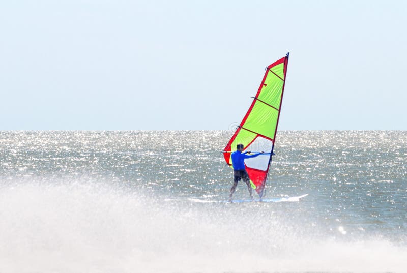 Windsurfer with a Red Sail Near the Pier Stock Photo - Image of ...