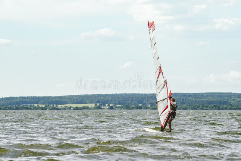 Alone Windsurfer Catches the Wind Editorial Photo - Image of sunlight ...