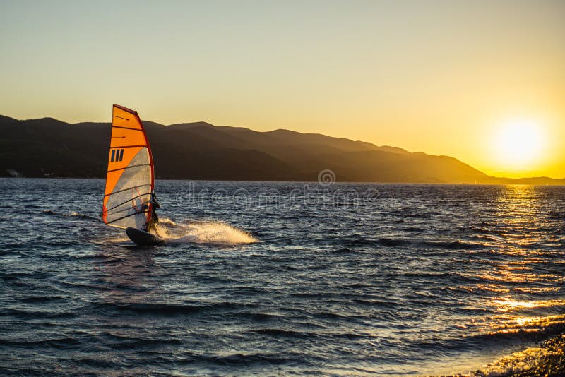 Windsurfer and Sun, Water and Mountains Editorial Photo - Image of ...