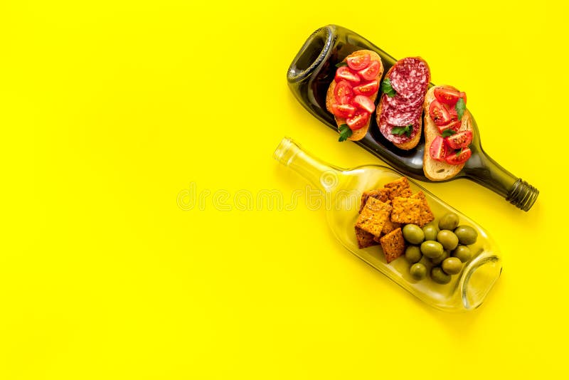 Wine Appetizer on Bottles As Dinnerware on Yellow Table Top View Copy ...