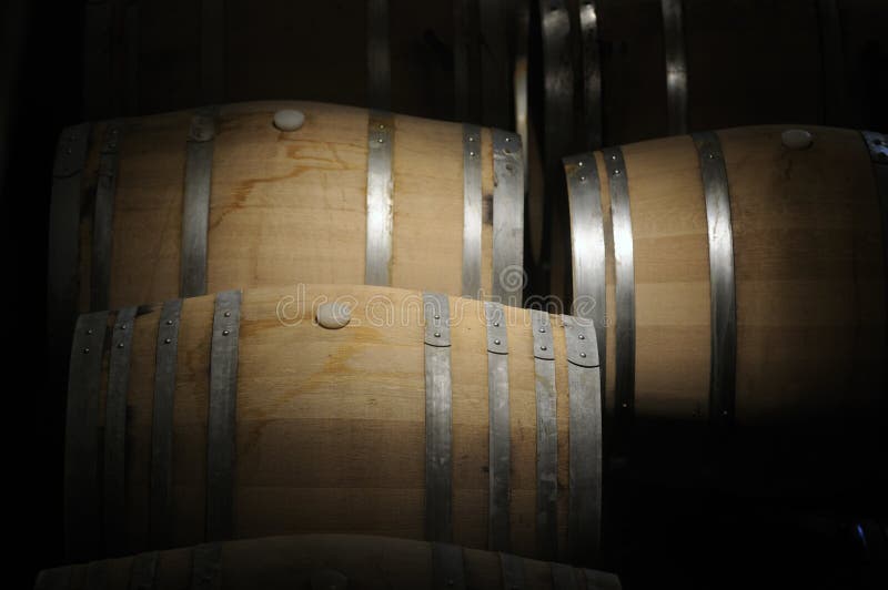 Wine Barrels in a Dark Cavern Stock Image - Image of illuminated, rivet ...