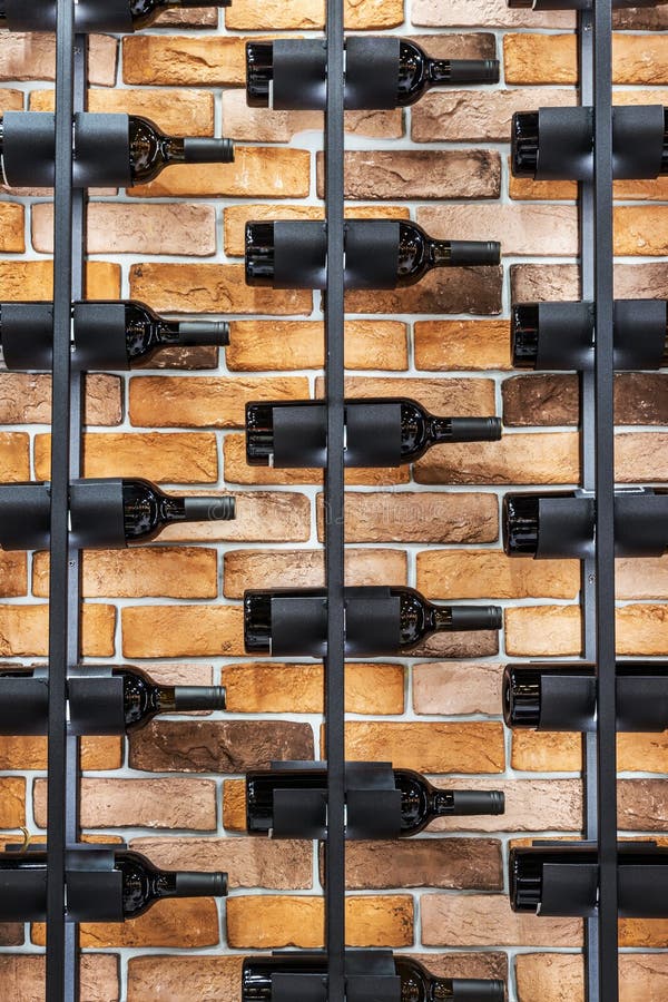 Wine Bottles Stacked on an Iron Rack in a Wine Cellar Stock Photo ...