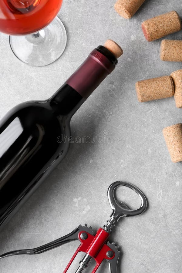 Wine Corks, Bottle, Glass of Drink and Corkscrew on Light Grey Table ...