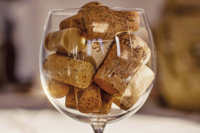Wine Corks in a Large Glass with Sun Reflecting on it Stock Photo ...