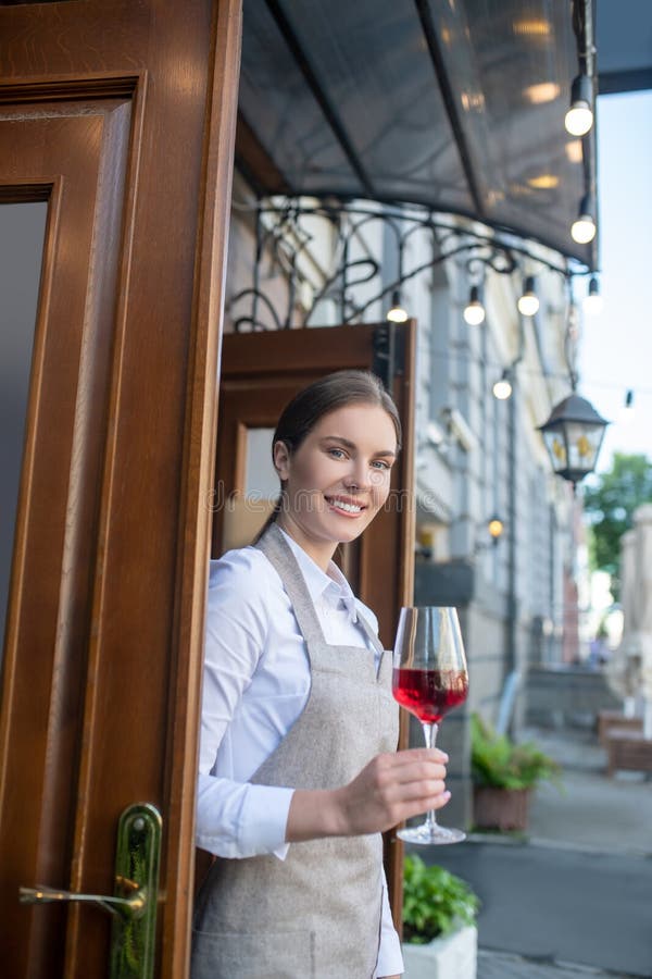 Smiling Cute Waitress in Grey Apron Holding Glass of Wine Stock Image ...