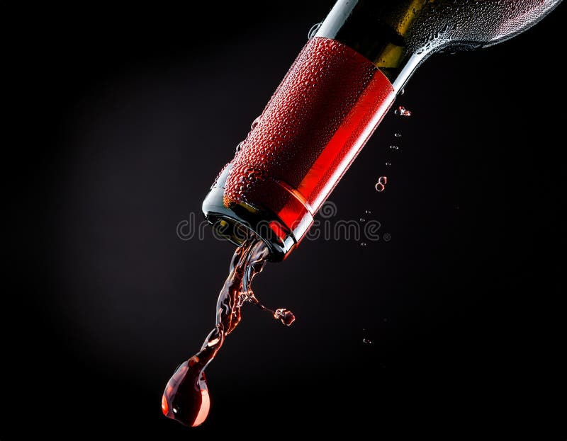 Wine Drops Falling from a Tilted Bottle Captured Mid-action To ...