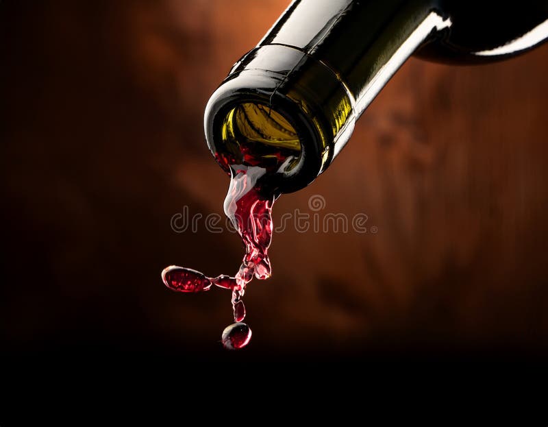 Wine Drops Falling from a Tilted Bottle Captured Mid-action To ...
