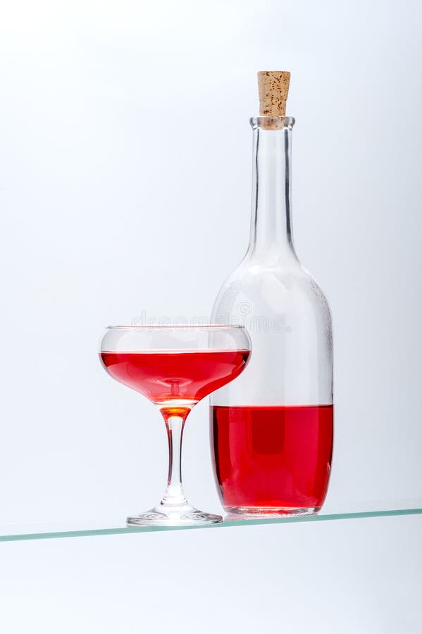Wine Glass and Bottle with Red Alcoholic Drink on a Light Gray ...