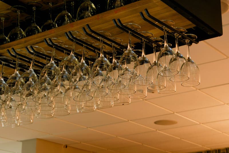 Wine glass on ceiling bar stock photo. Image of clean - 135367652