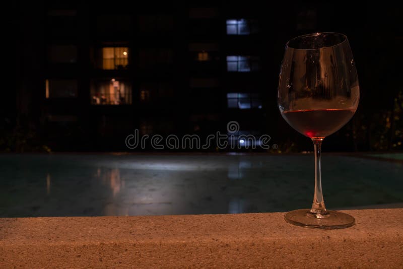 Wine Glass with Red Wine on the Edge of the Pool Stock Image - Image of ...