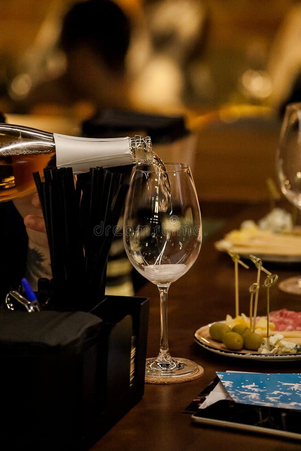 Wine Glasses and Bottles of Wine in the Entourage of the Wine Bar Stock ...