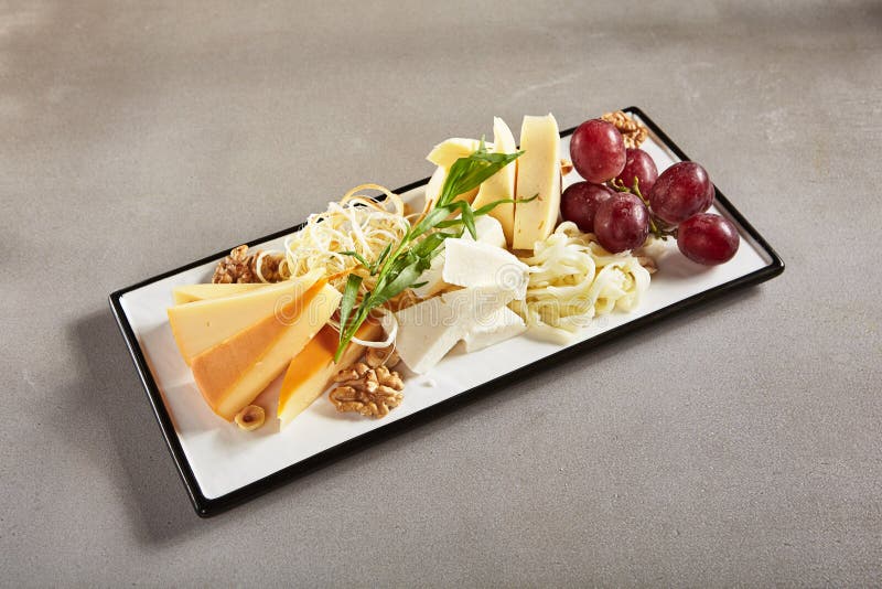 Wine Plate with Cheese Mix, Nuts and Grapes on White Rectangular Stock ...