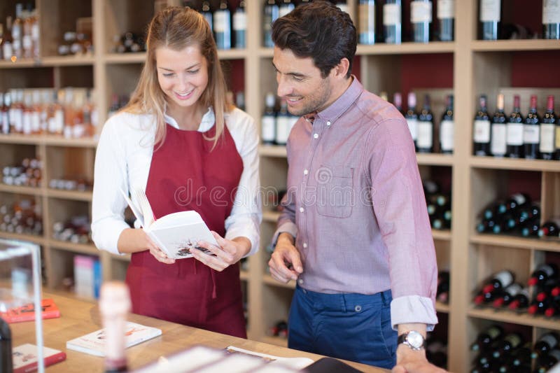 Wine Store Manager and Saleswoman Reading Book Stock Image - Image of ...