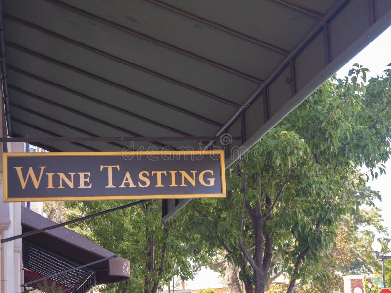 Wine Tasting Sign Hanging in Front of Downtown Shops Stock Photo ...