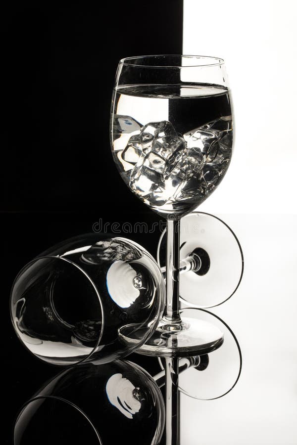 Wineglasses on a Black Glass Studio Background Stock Photo - Image of ...