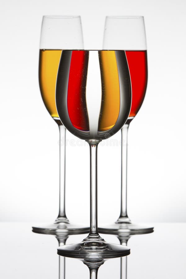 Wineglasses on a Shiny Surface with Different Colour Fluids that Stock ...