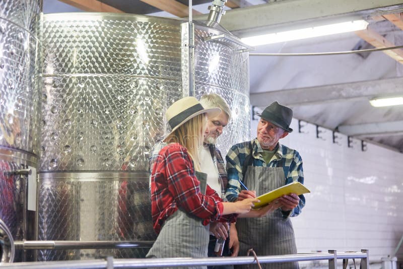 Winemaker and Team with Checklist in the Wine Cellar Stock Image ...