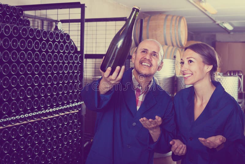 Winery Workers Holding Bottle of Wine Stock Image - Image of ...