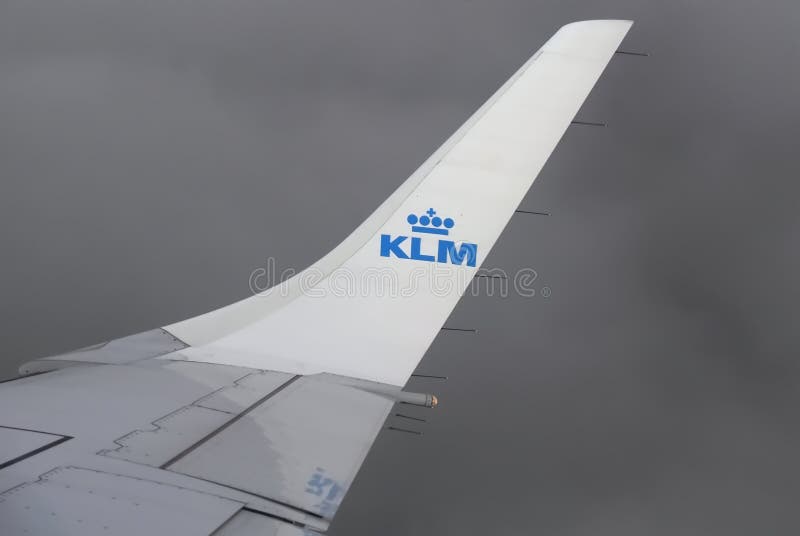 Wing of an Airplane of the Airline KLM in Flight with Cloudy Background ...
