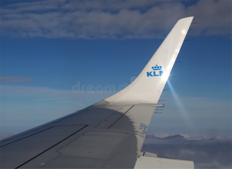 Wing of an Airplane of the Airline KLM in Flight with Cloudy Background ...