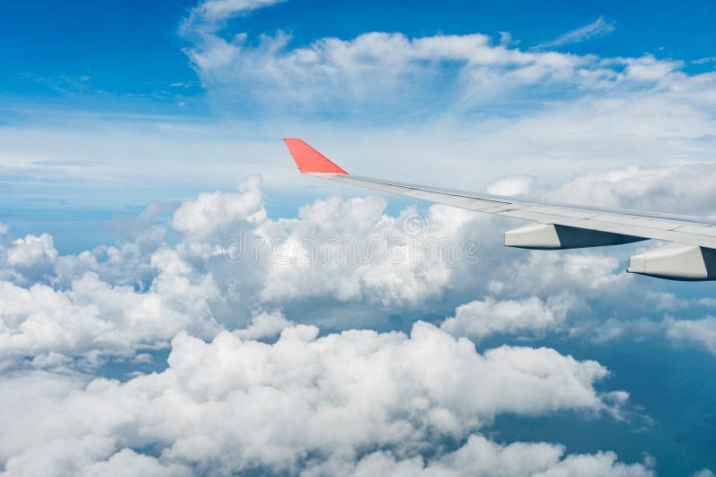 The Wing of an Airplane on the Background of Clouds in Flight. a Clear ...