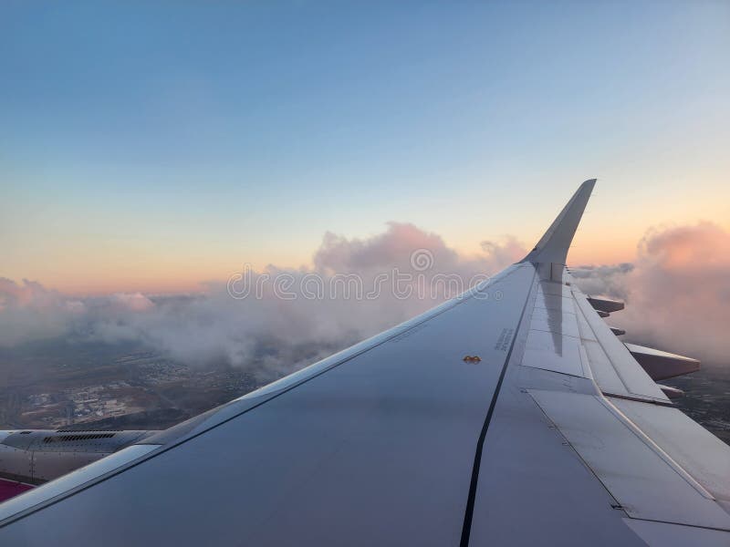 Wing of an Airplane Captured at Sunset during the Flight Stock Photo ...
