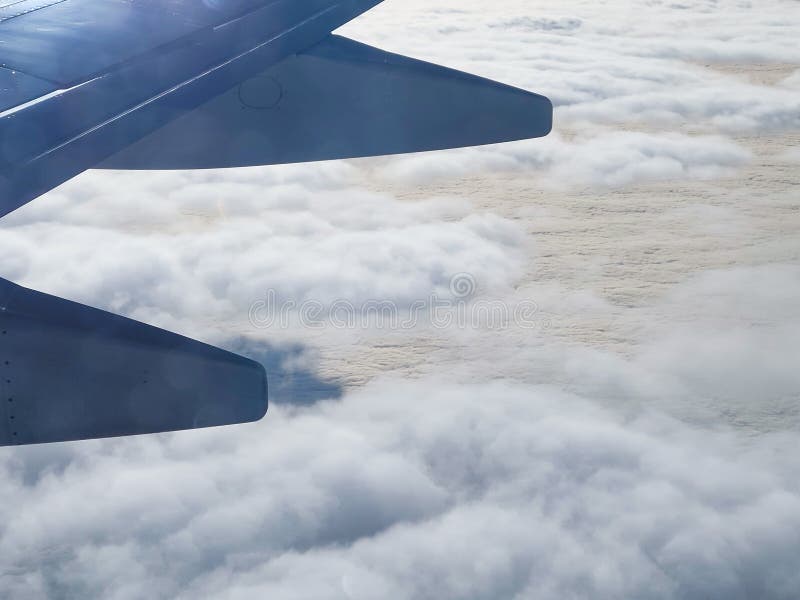 Wing of an Airplane Flying Above the Blue Sky Clouds. Flight, Travel ...