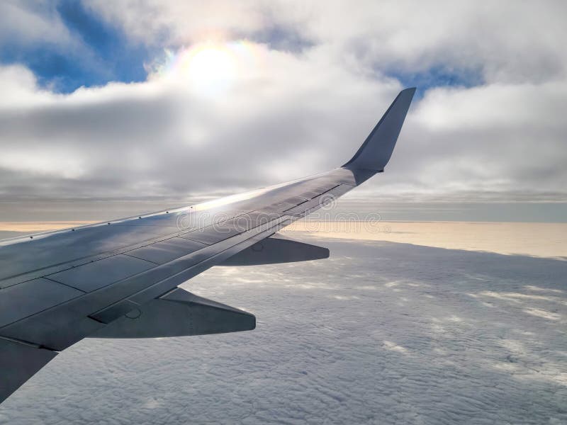 Wing of an Airplane Flying Above the Blue Sky Clouds. Flight, Travel ...