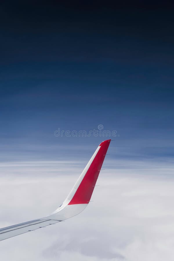 Wing of an Airplane Flying Above the Clouds on a Clear Day during Blue ...